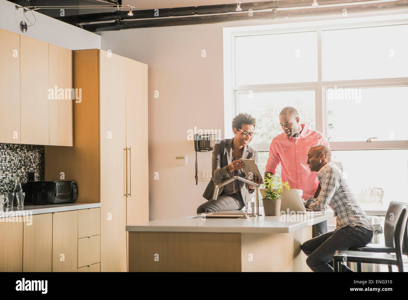 Business people talking in office kitchen Stock Photo - Alamy