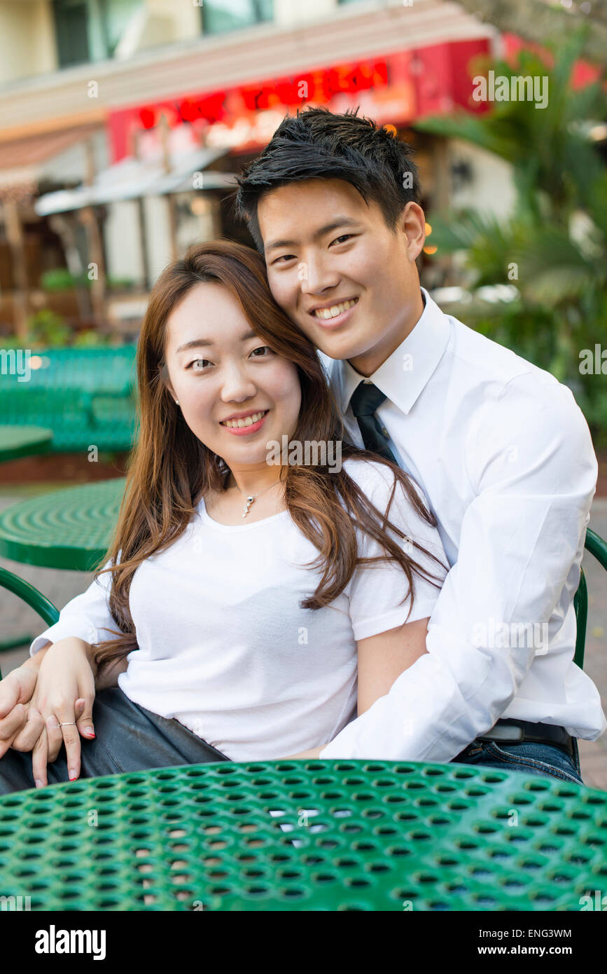 Korean couple hugging at sidewalk cafe Stock Photo - Alamy
