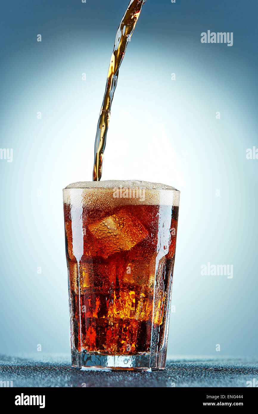 Cola pouring in a glass Stock Photo - Alamy