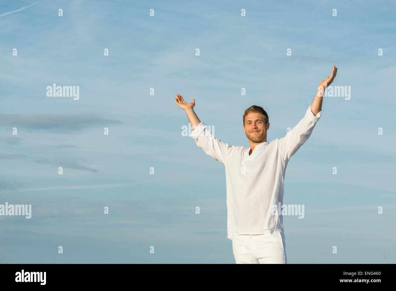 Caucasian man standing with arms raised outdoors Stock Photo - Alamy