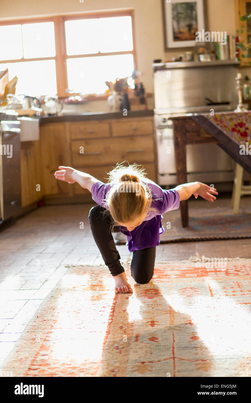 Caucasian girl dancing in kitchen Stock Photo - Alamy
