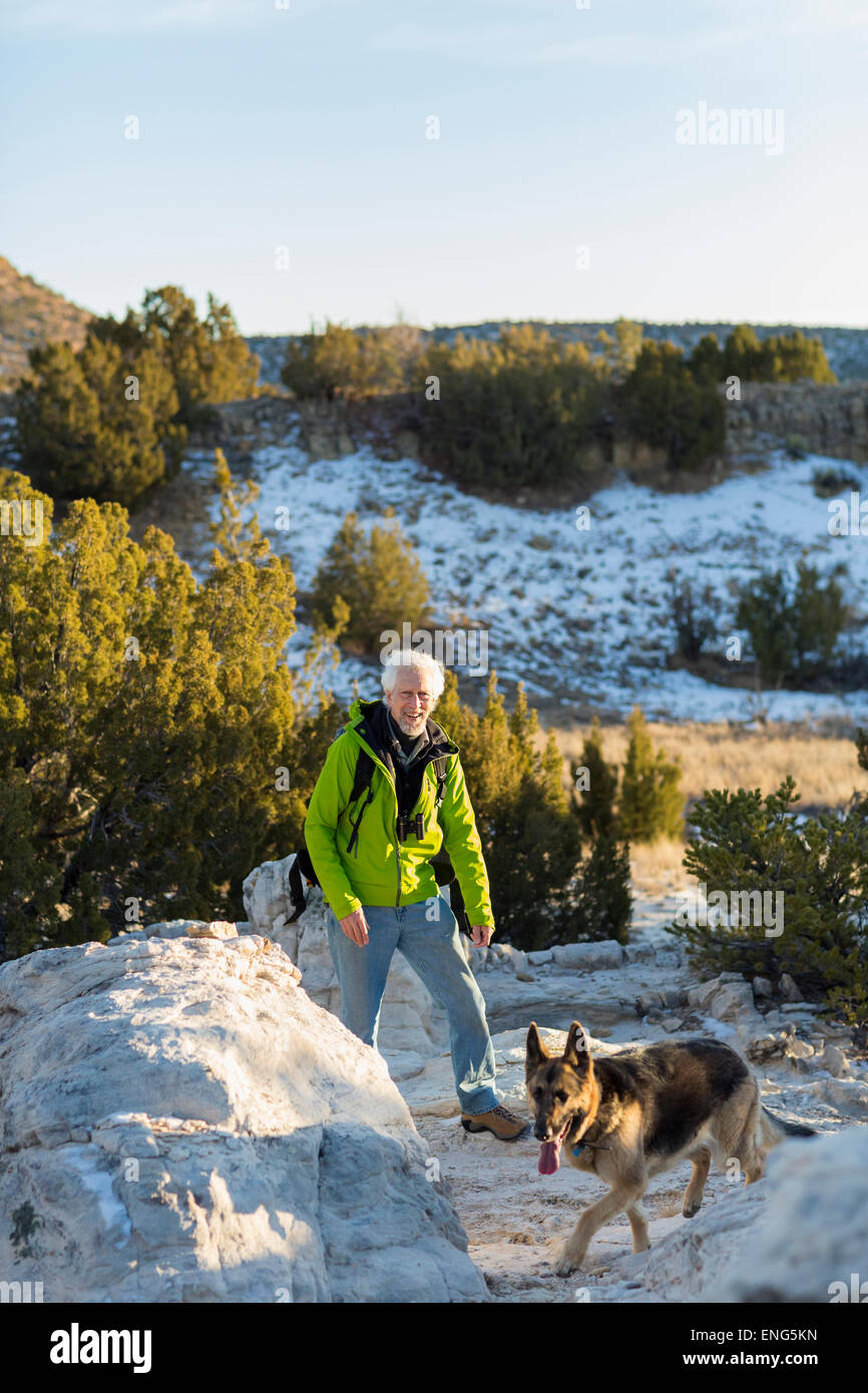 Older man and dog standing on remote rock formations Stock Photo - Alamy