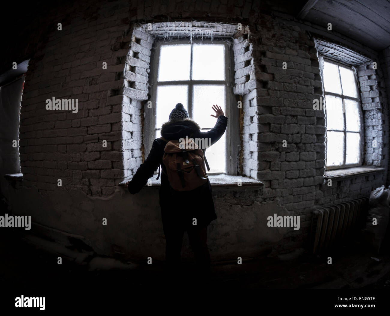 Caucasian man waving through illuminated window at night Stock Photo ...