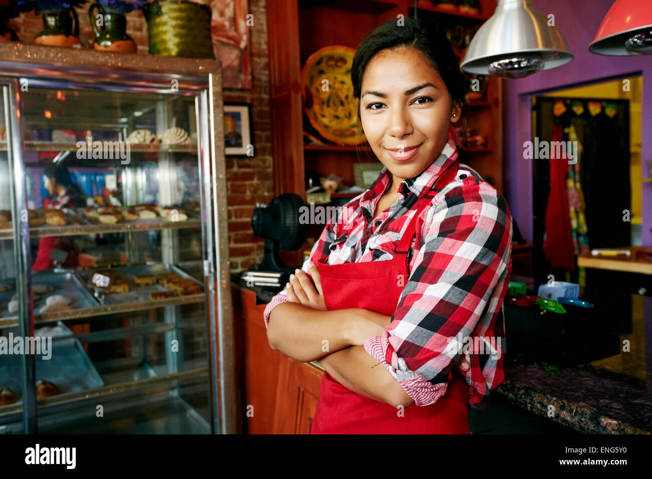 Hispanic waitress smiling in bakery Stock Photo - Alamy