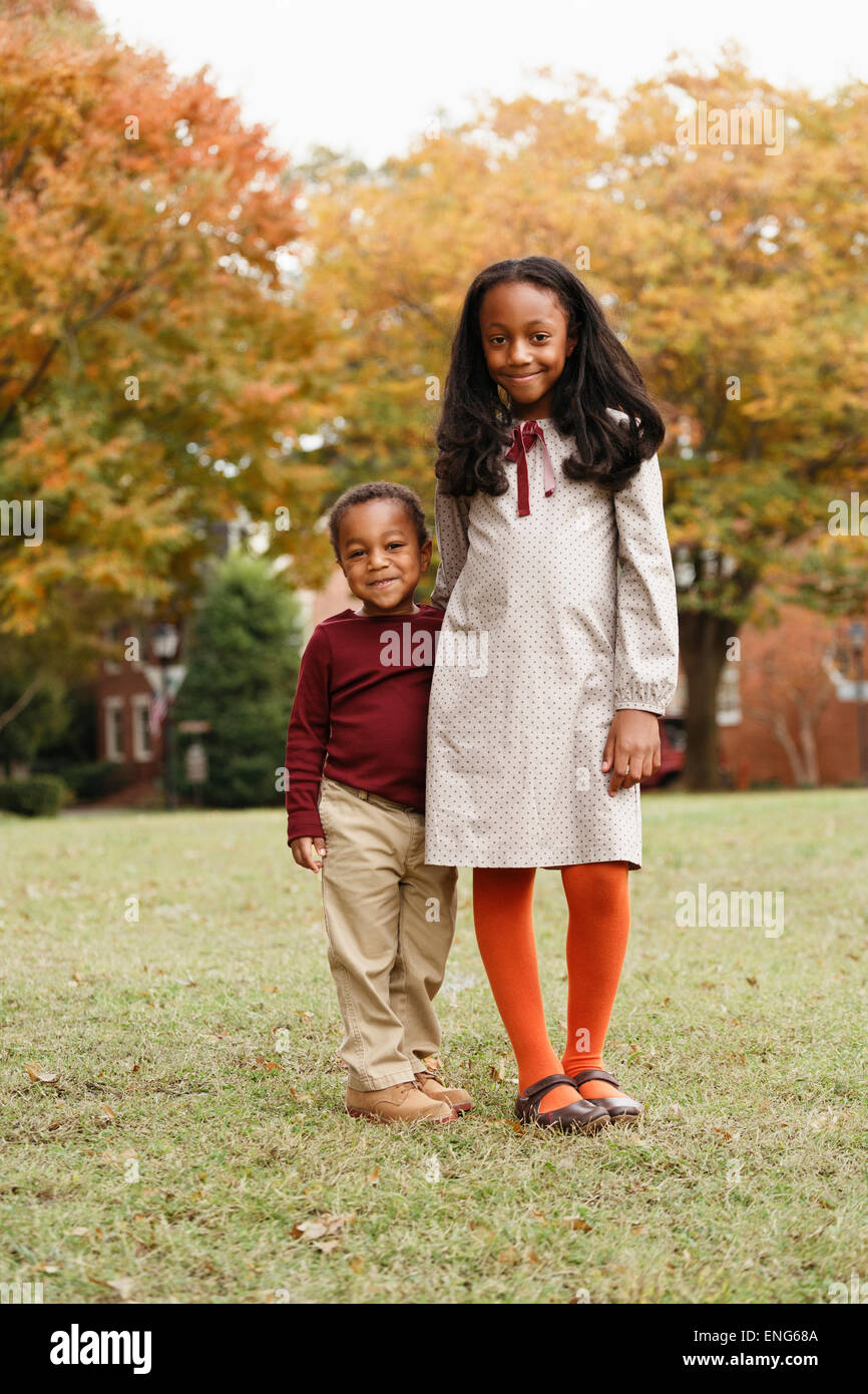 African American brother and sister smiling in park Stock Photo - Alamy