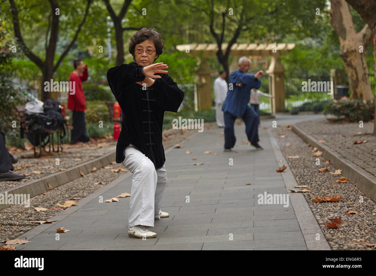 A group of people practising taiji quan (or taichi) in a city centre ...