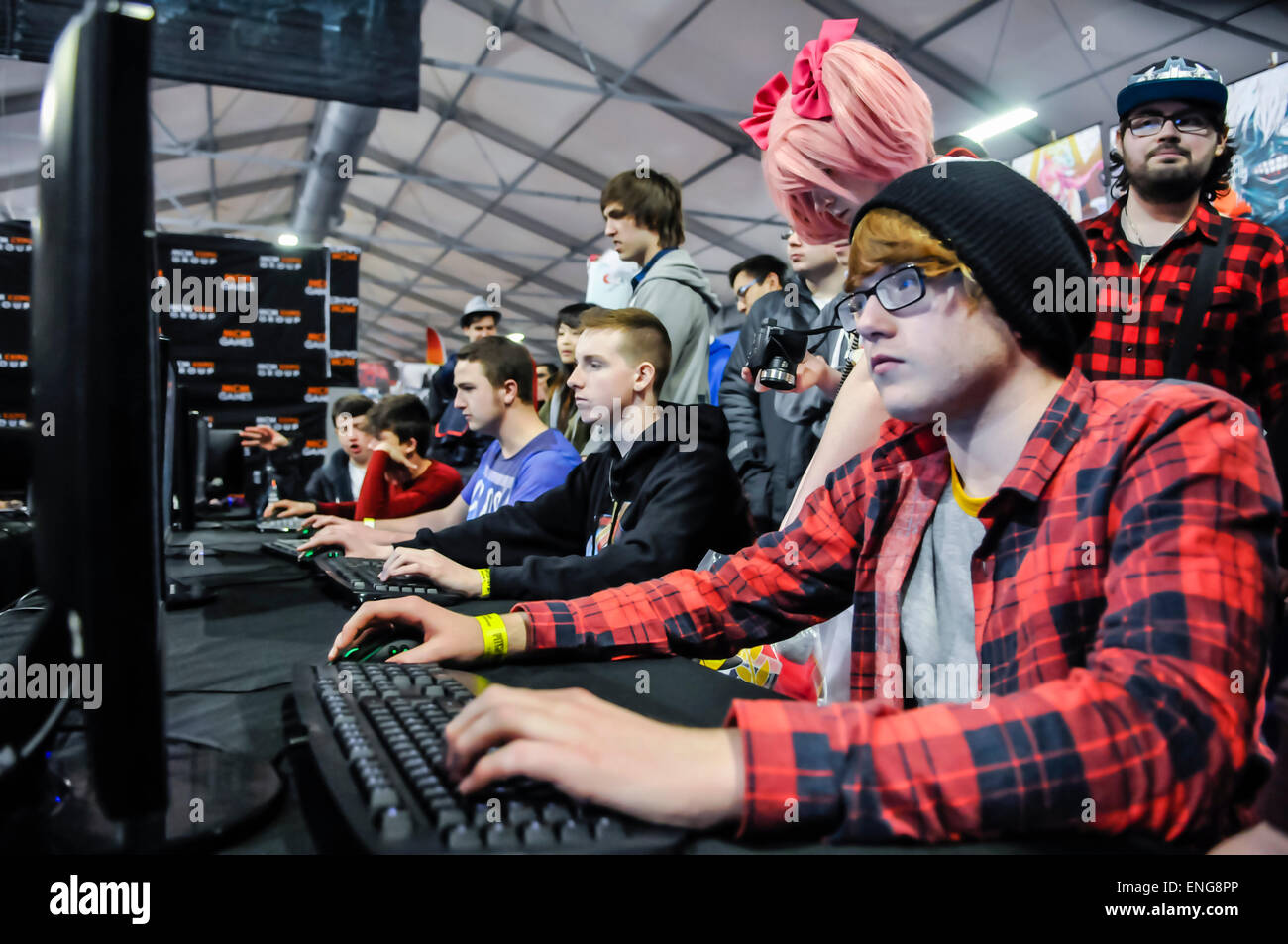 Teenage boys play computer video games at a LAN party at a comicon ...