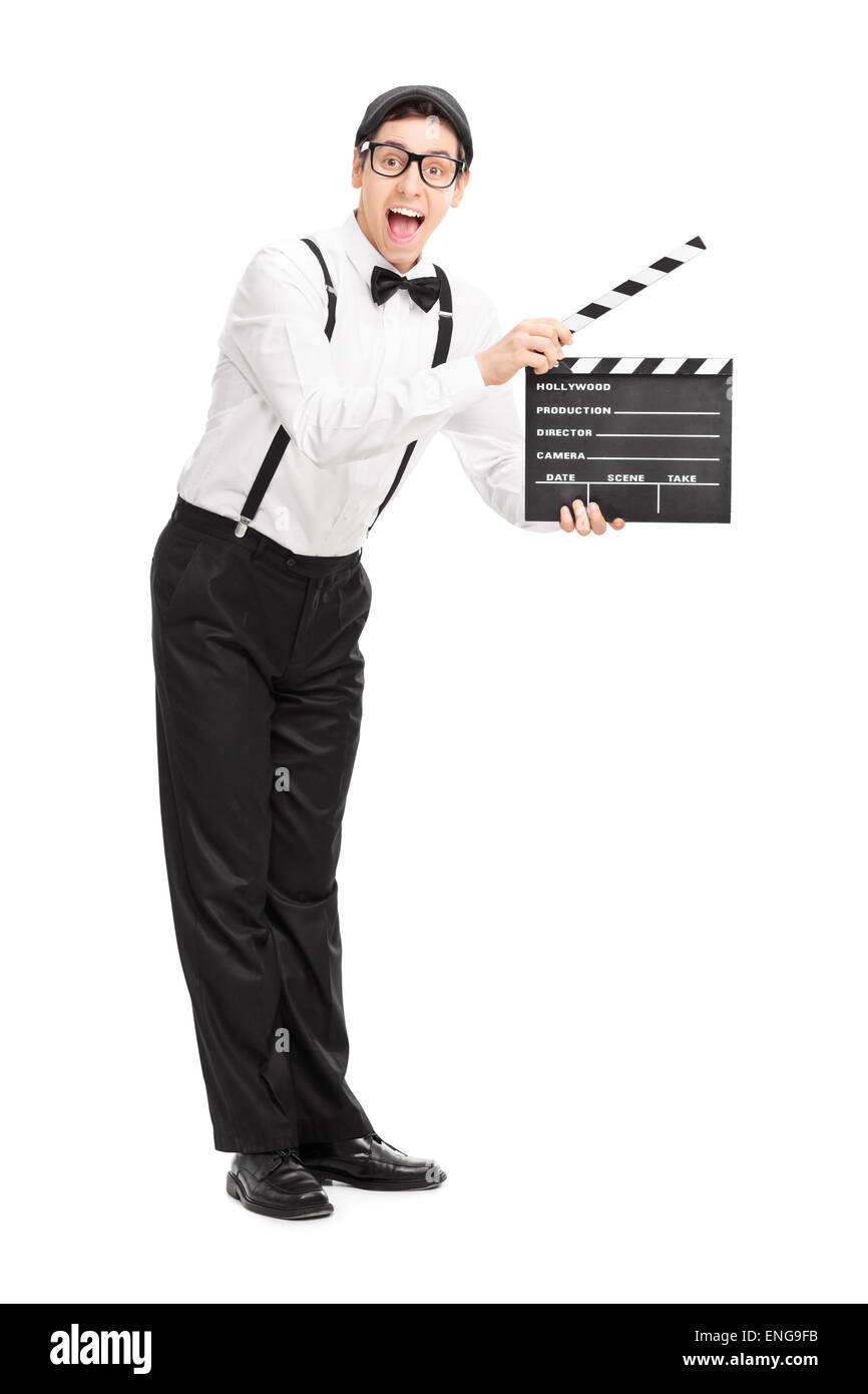 Full length portrait of a young movie director holding a clapperboard ...