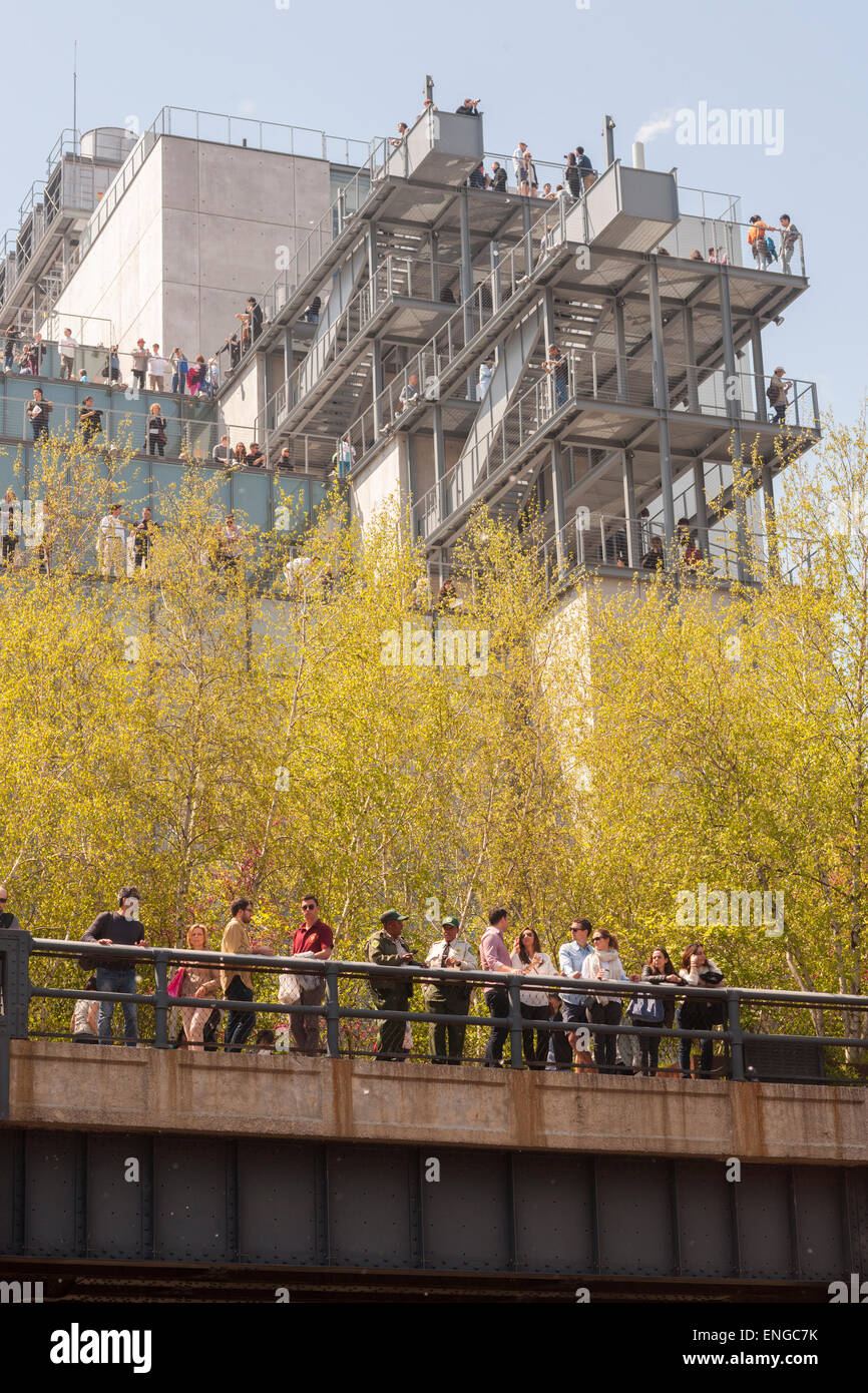 Visitors crowd the balconies of the Whitney Museum of American Art ...