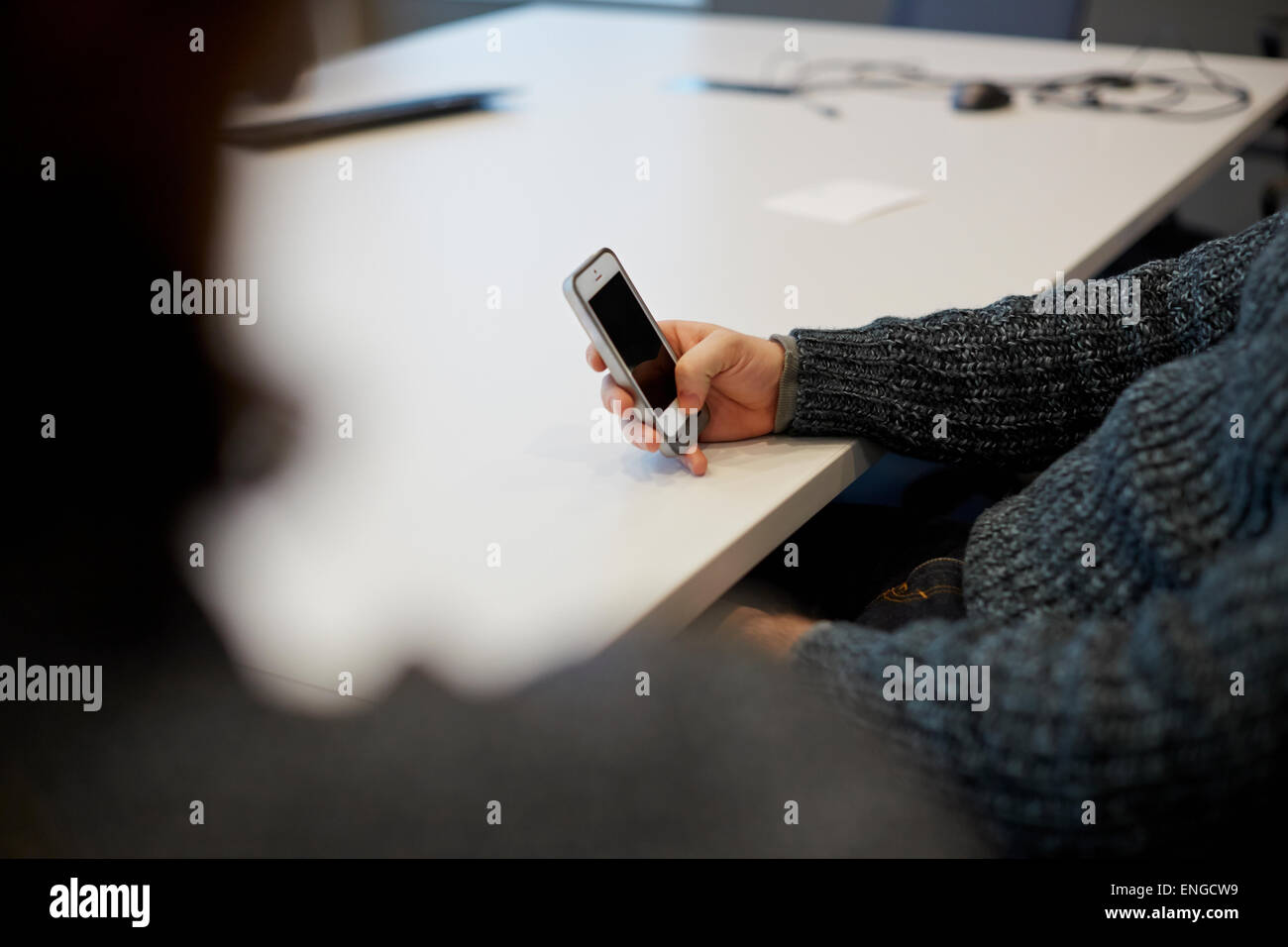 Young man seated table hi-res stock photography and images - Alamy