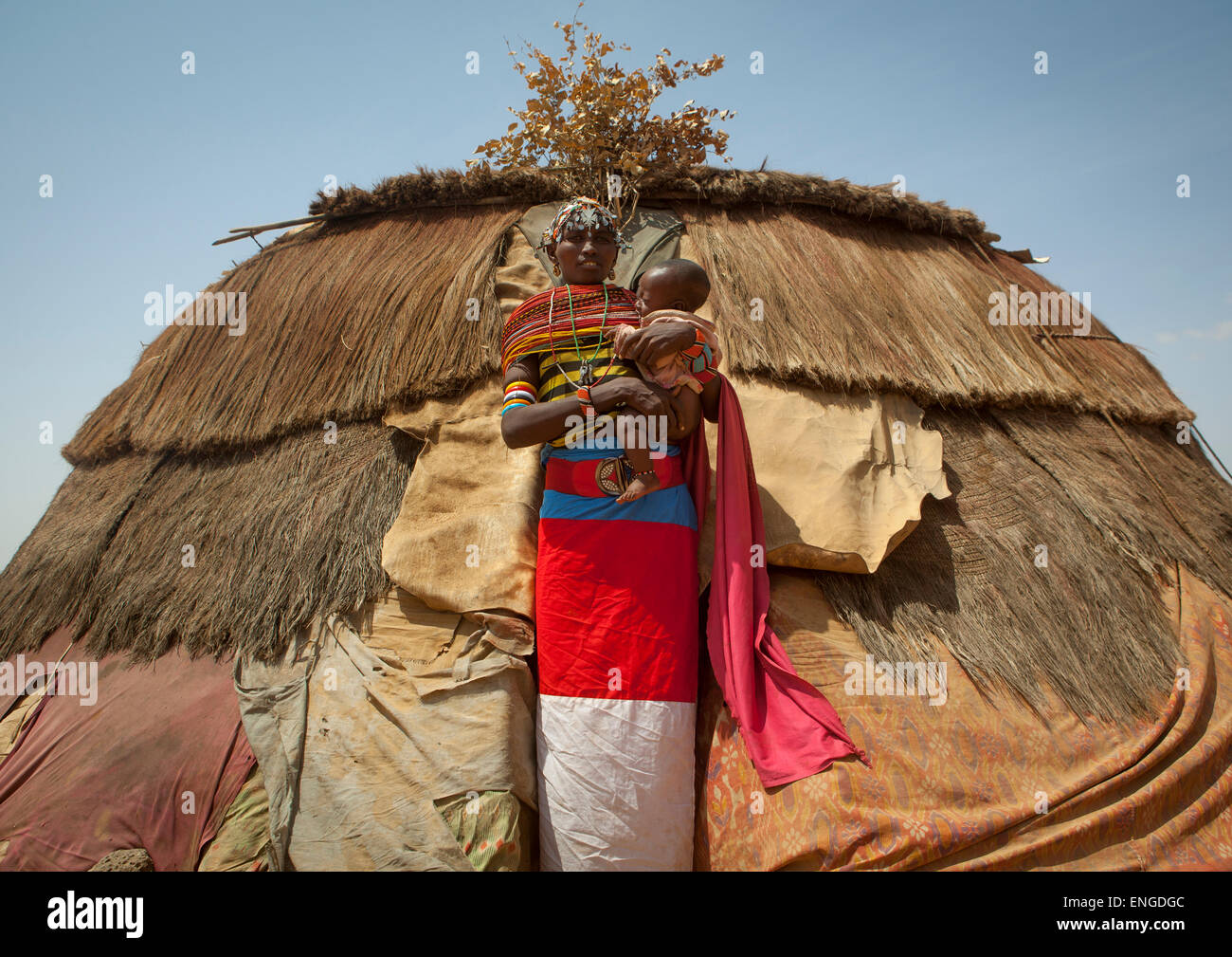 Rendille Tribeswoman In Front Of Her Hut Holding Her Baby, Marsabit ...
