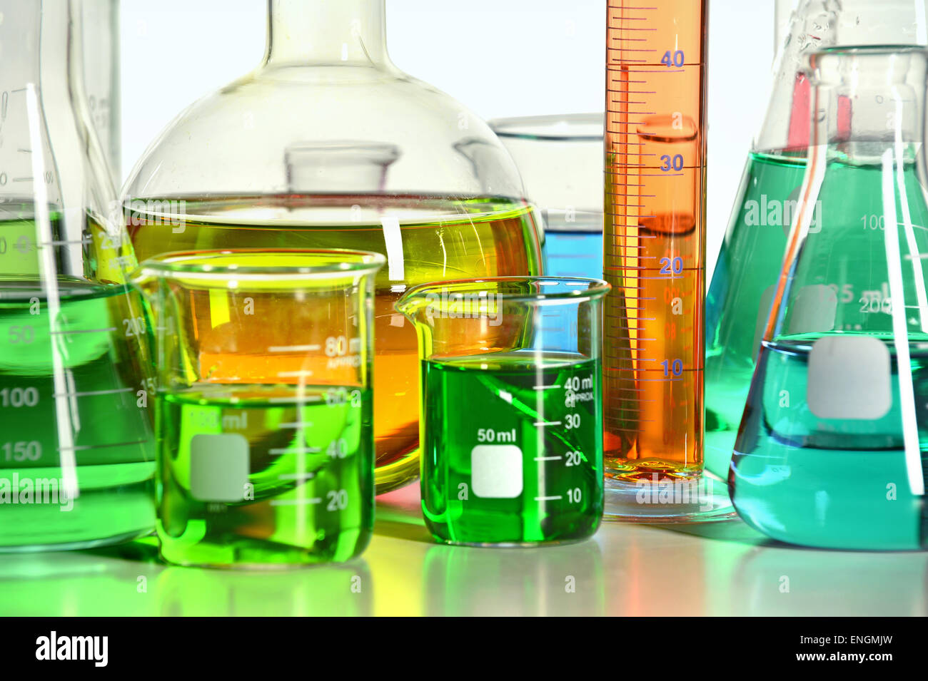 Close up view of various laboratory glassware on reflective table Stock ...