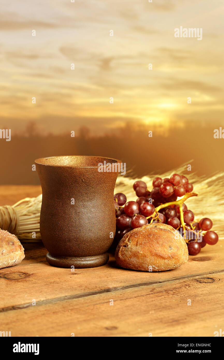 Communion cup with bread, grapes and wheat on wooden table Stock Photo ...