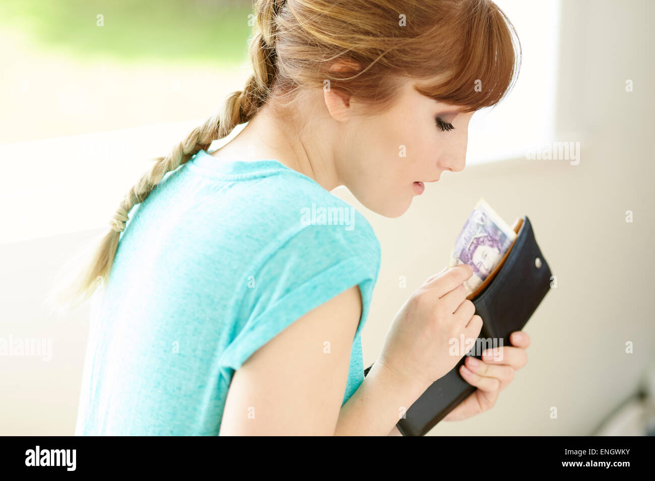 Girl taking money from partners wallet Stock Photo - Alamy
