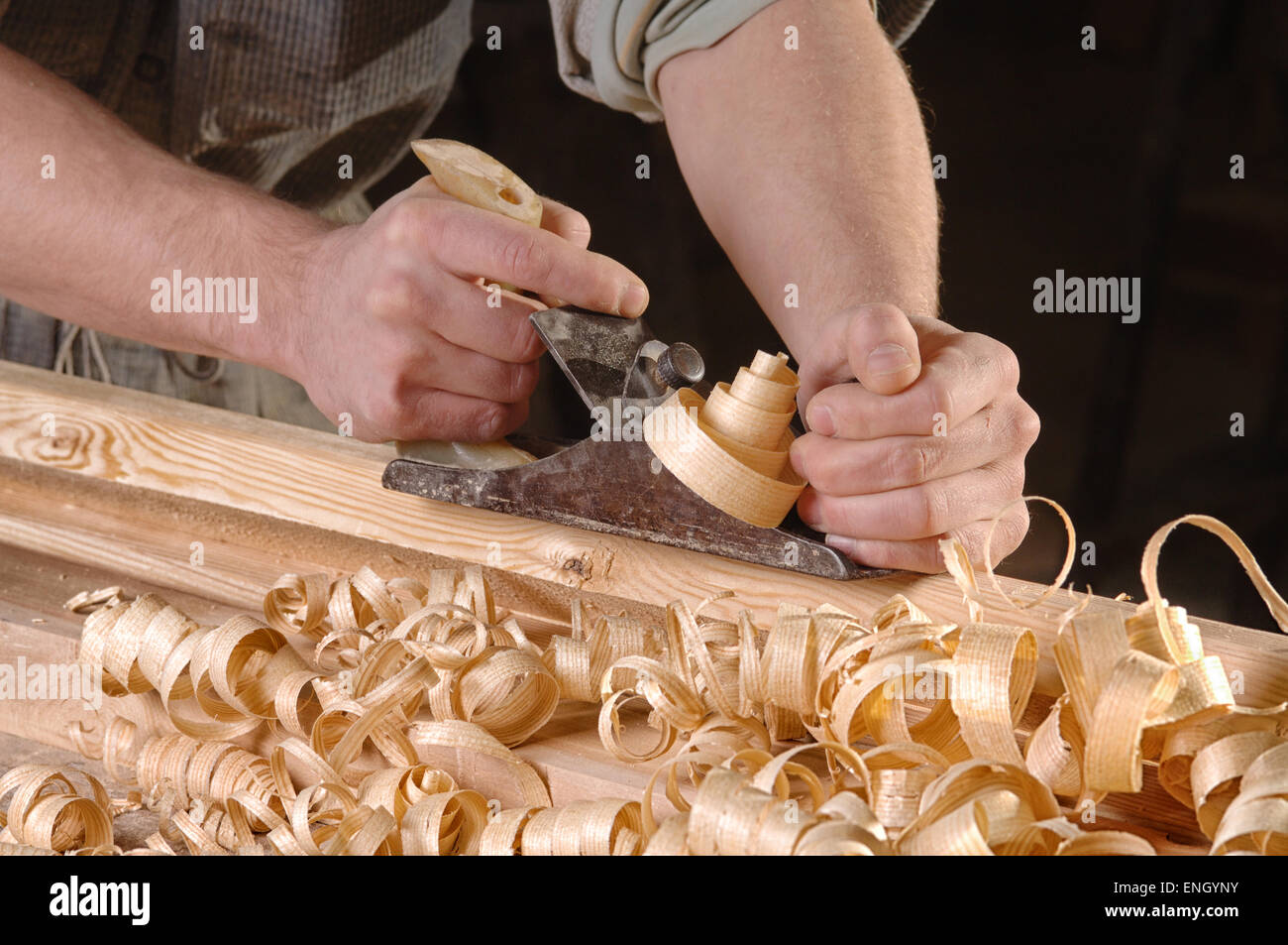 Man hands with carpenters plane on wooden background Stock Photo - Alamy