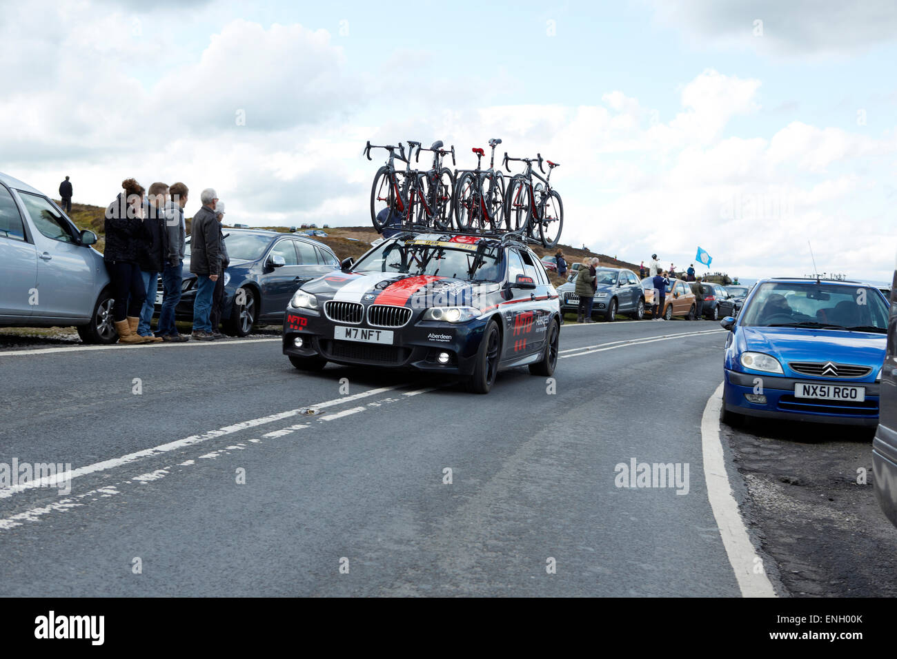 Competitors support car at The Tour of Yorkshire cycle race on Day 3 ...