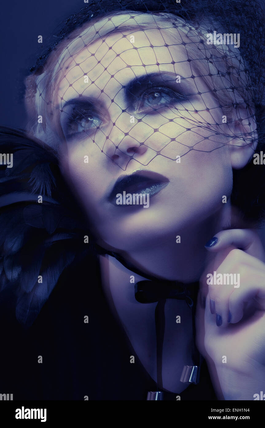 Beauty portrait of pale young woman with black lipstick, mesh over face ...