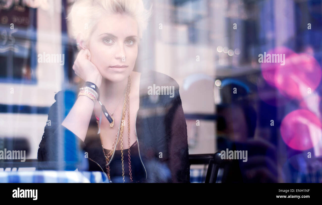 Woman sitting in café hi-res stock photography and images - Alamy