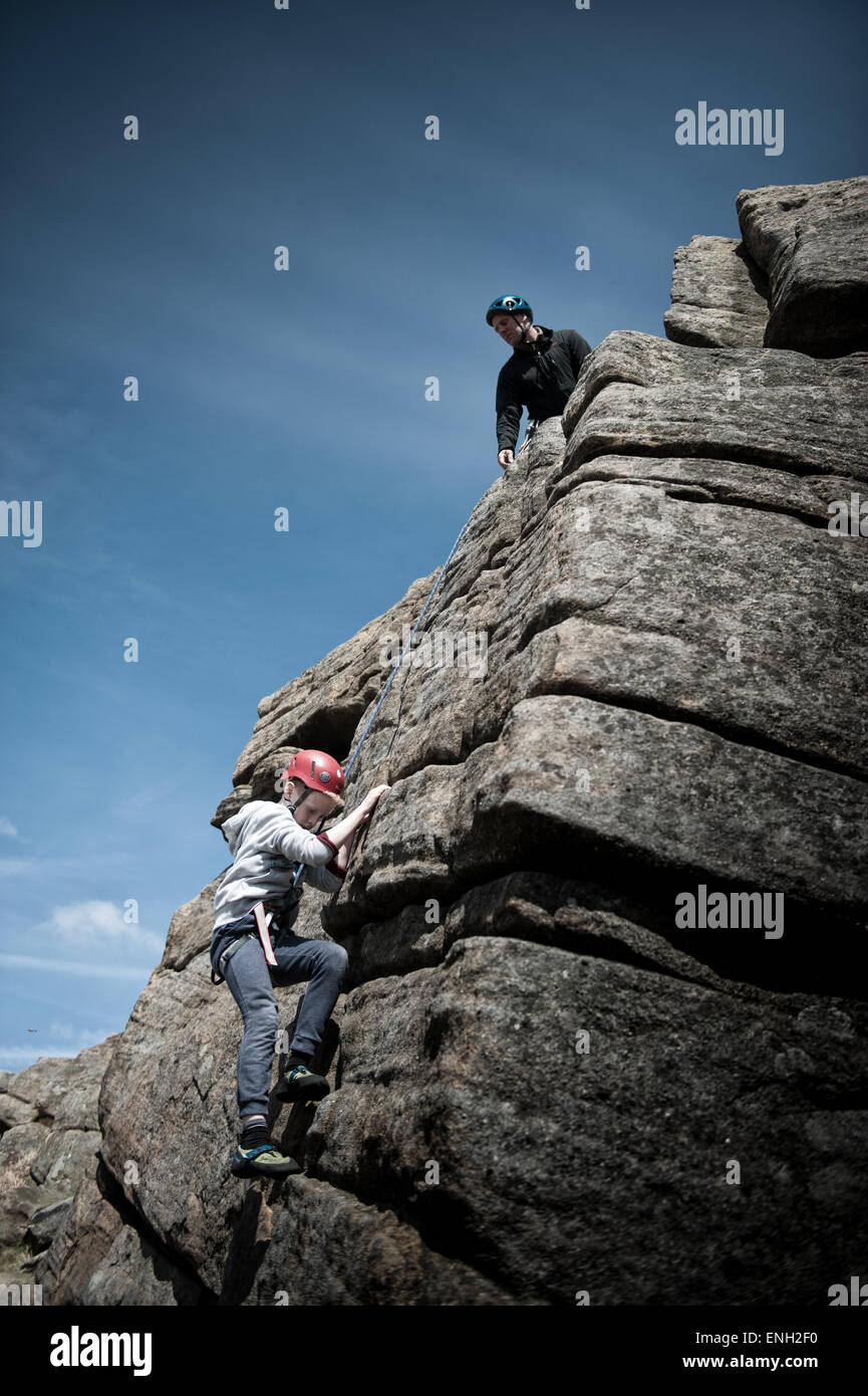 A young boy climbing on Stanage Edge in the Peak District Stock Photo ...