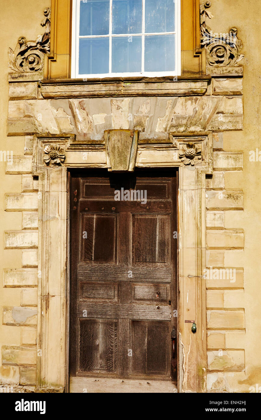Wooden door with decorative stone surround at Calke Abbey, Derbyshire ...