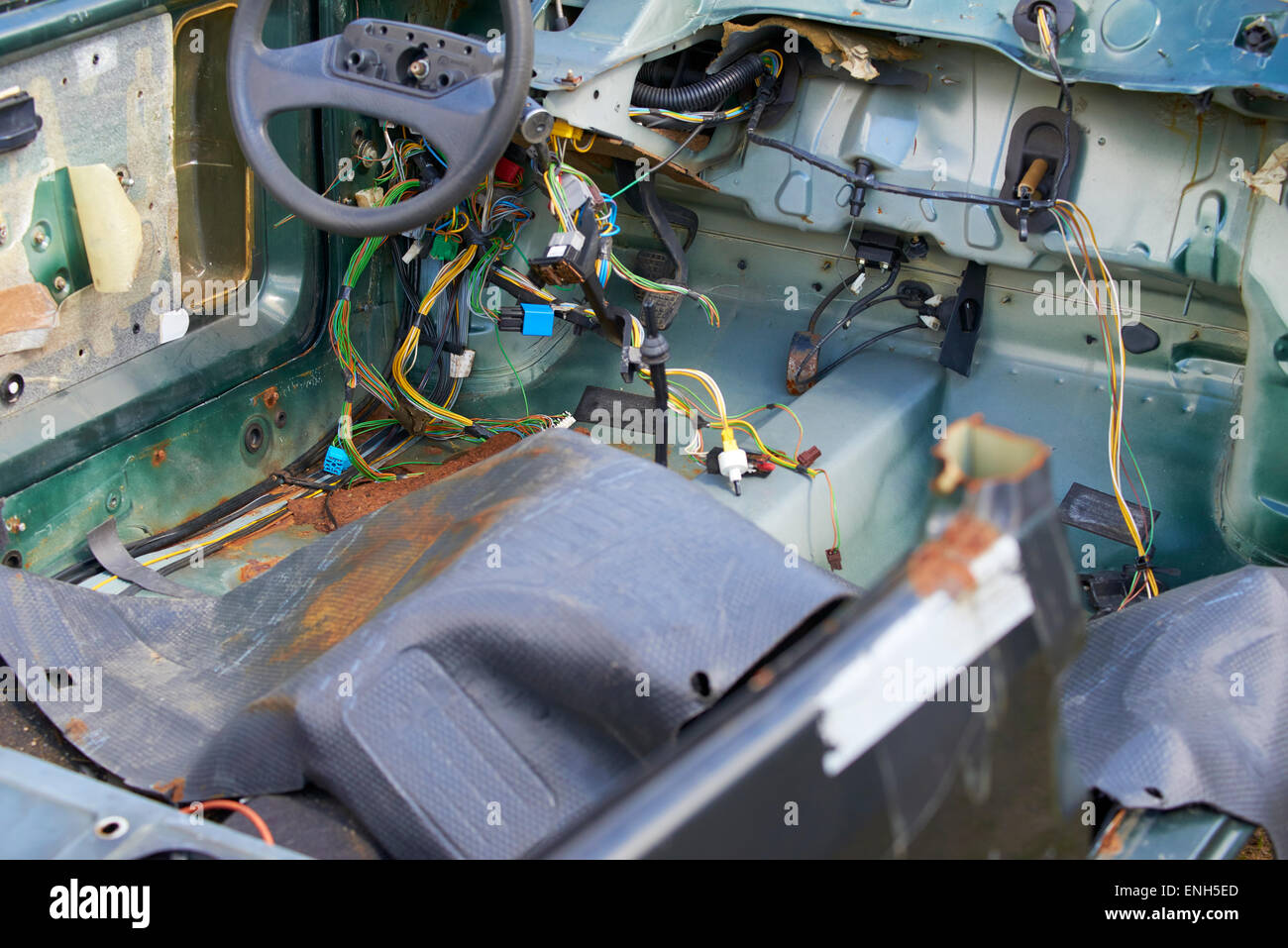Junk Wrecked Car with Parts Removed in Wrecking Yard Stock Photo - Alamy