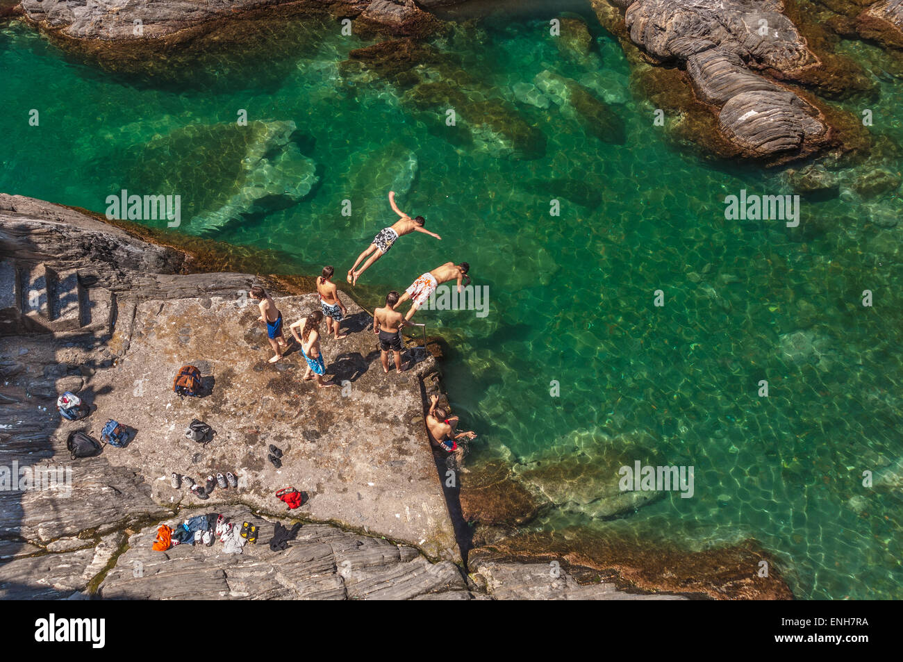 Swimmers diving off rocks in Manarola, Cinque Terre, Italy Stock Photo ...