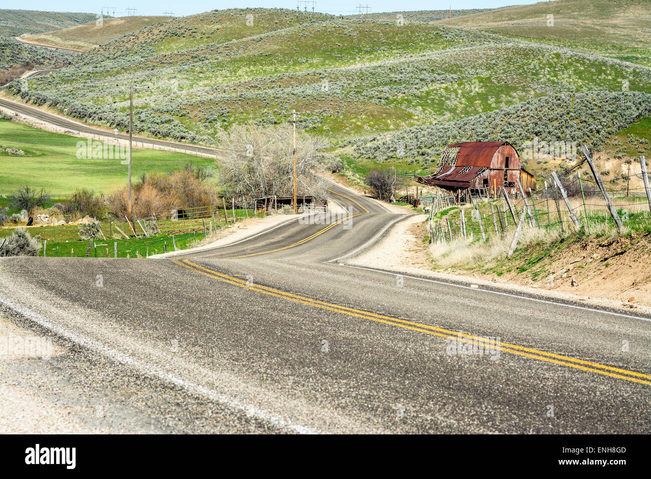 PAved country road pass by a farm with barn Stock Photo - Alamy