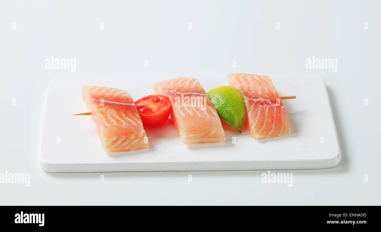 Raw fish skewer on a cutting board Stock Photo - Alamy