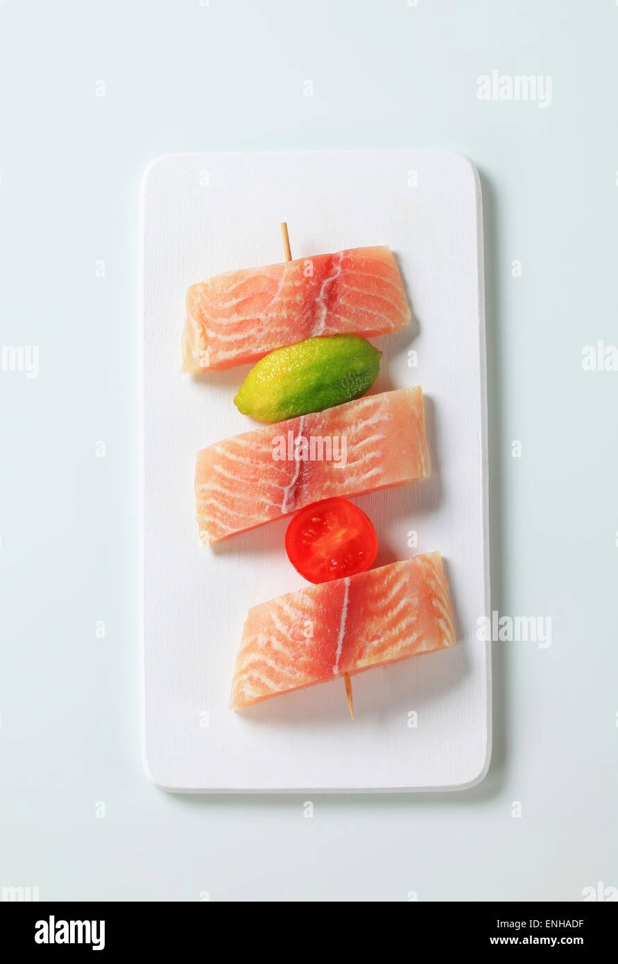 Raw fish skewer on a cutting board Stock Photo - Alamy