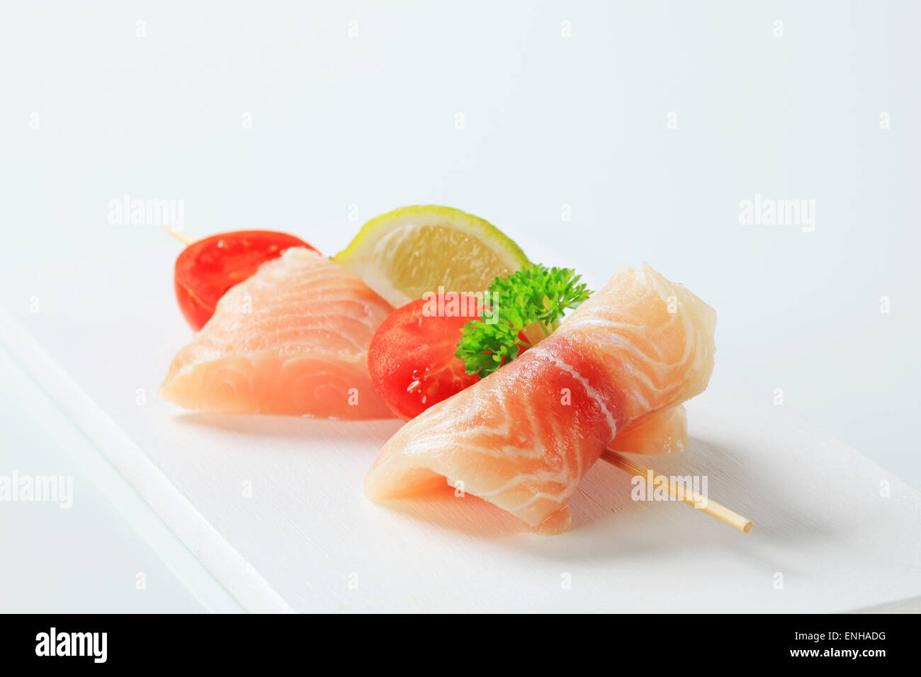 Raw fish skewer on a cutting board Stock Photo - Alamy