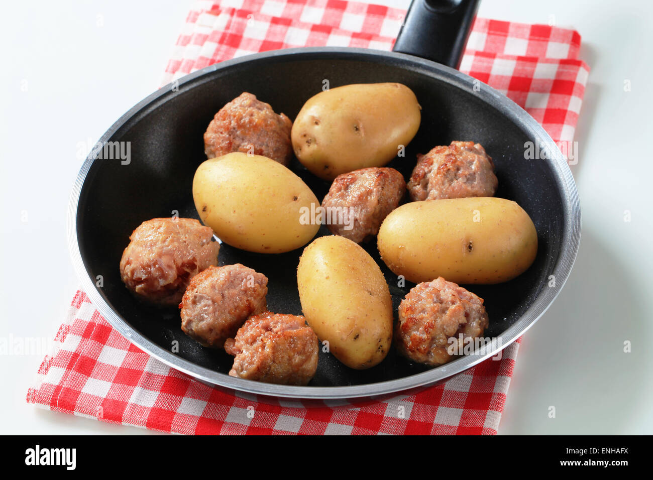 Pan-fried meatballs and potatoes in a fry pan Stock Photo - Alamy