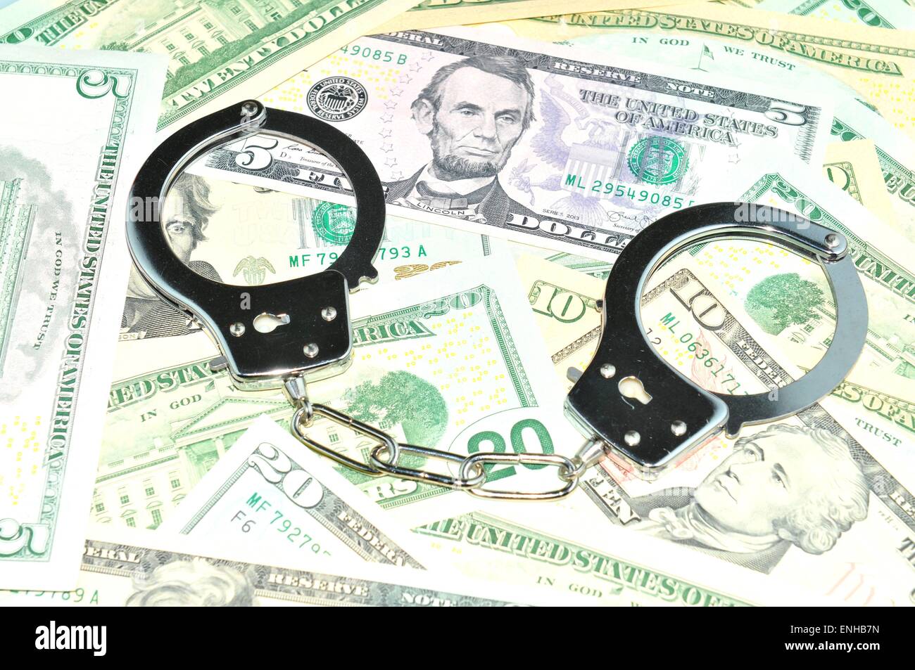 Financial crime concept with handcuffs on money background Stock Photo ...