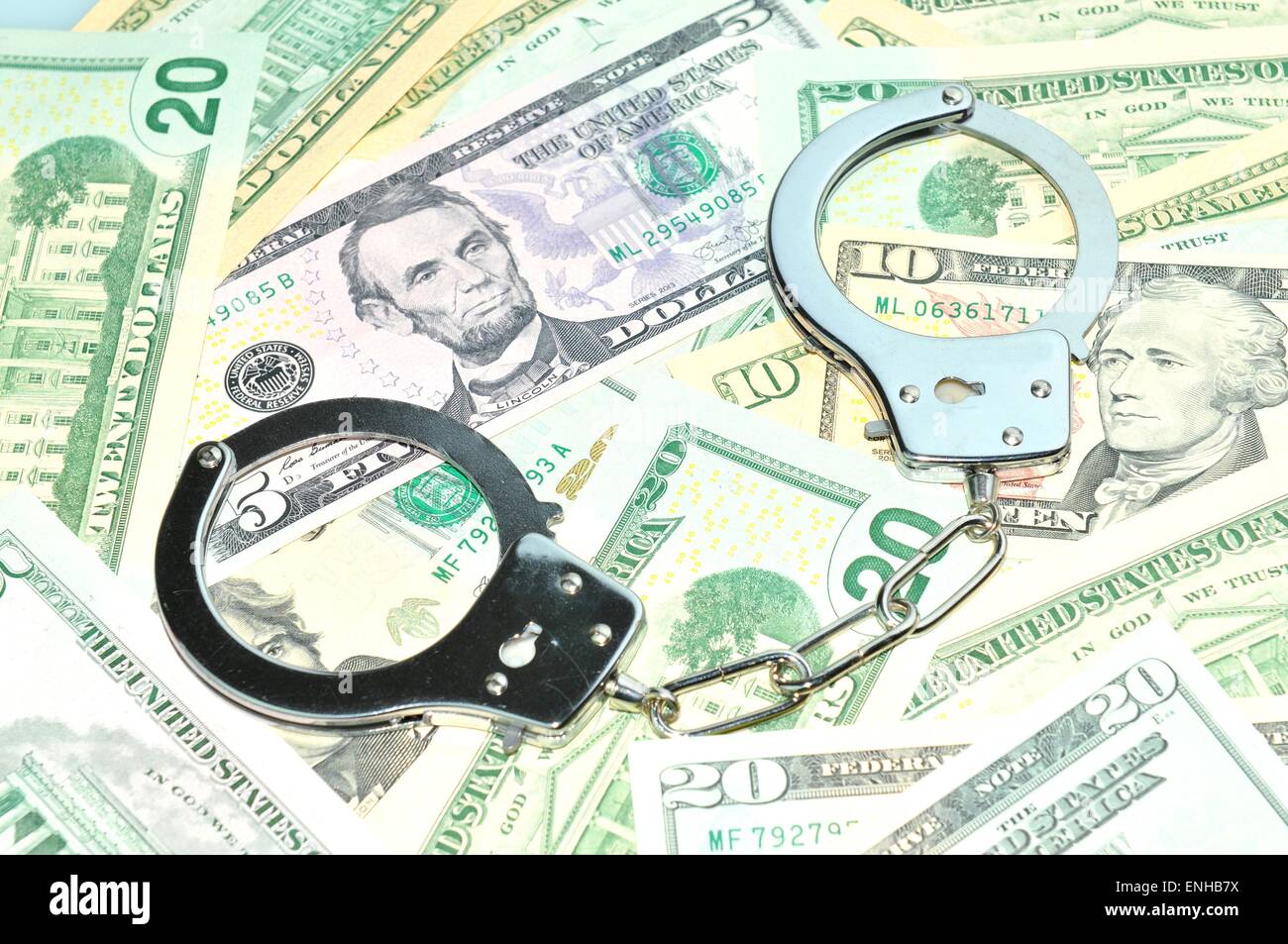 Financial crime concept with handcuffs on money background Stock Photo ...