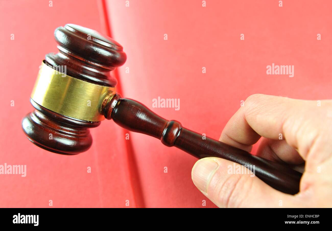 Judge holding a gavel Stock Photo - Alamy