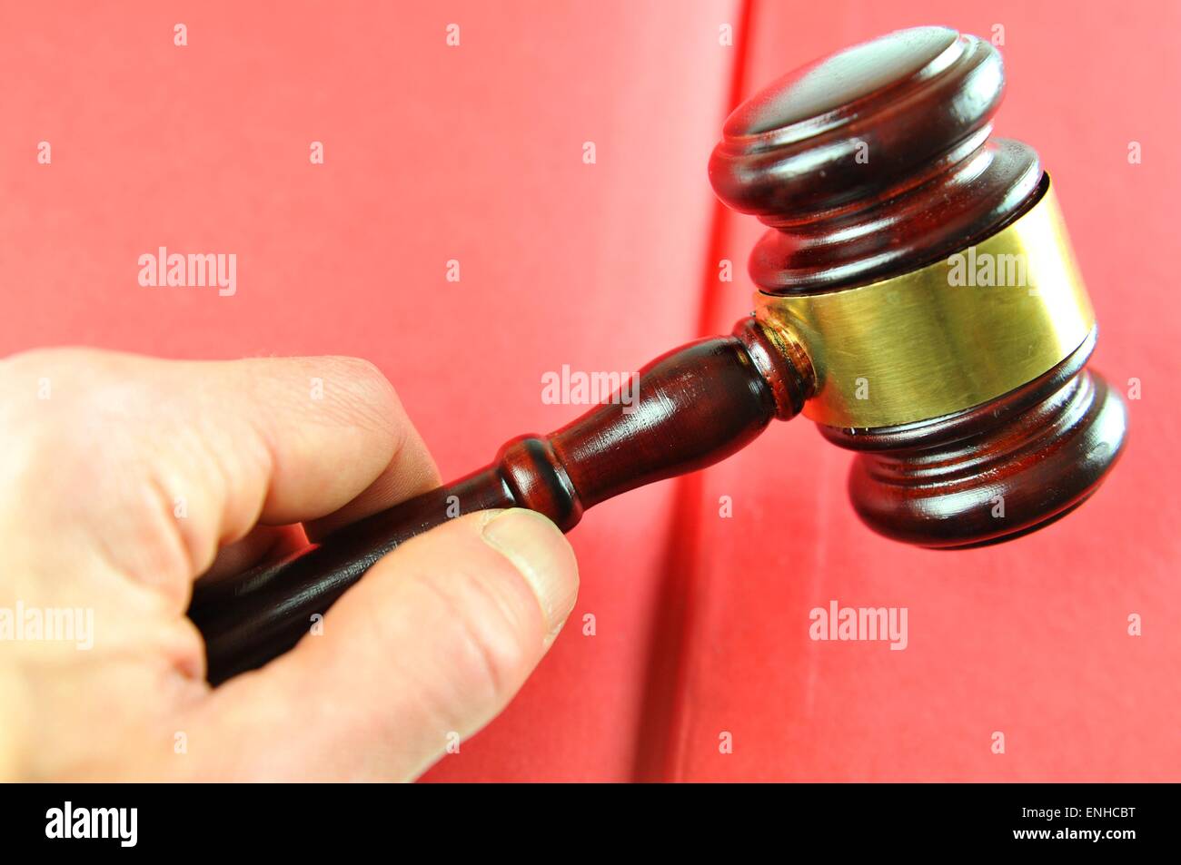 Judge holding a gavel Stock Photo - Alamy