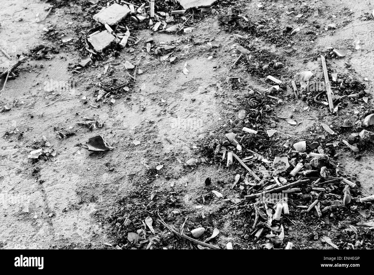 Dusty and dirty concrete floor with old cigarette butts and rubble ...