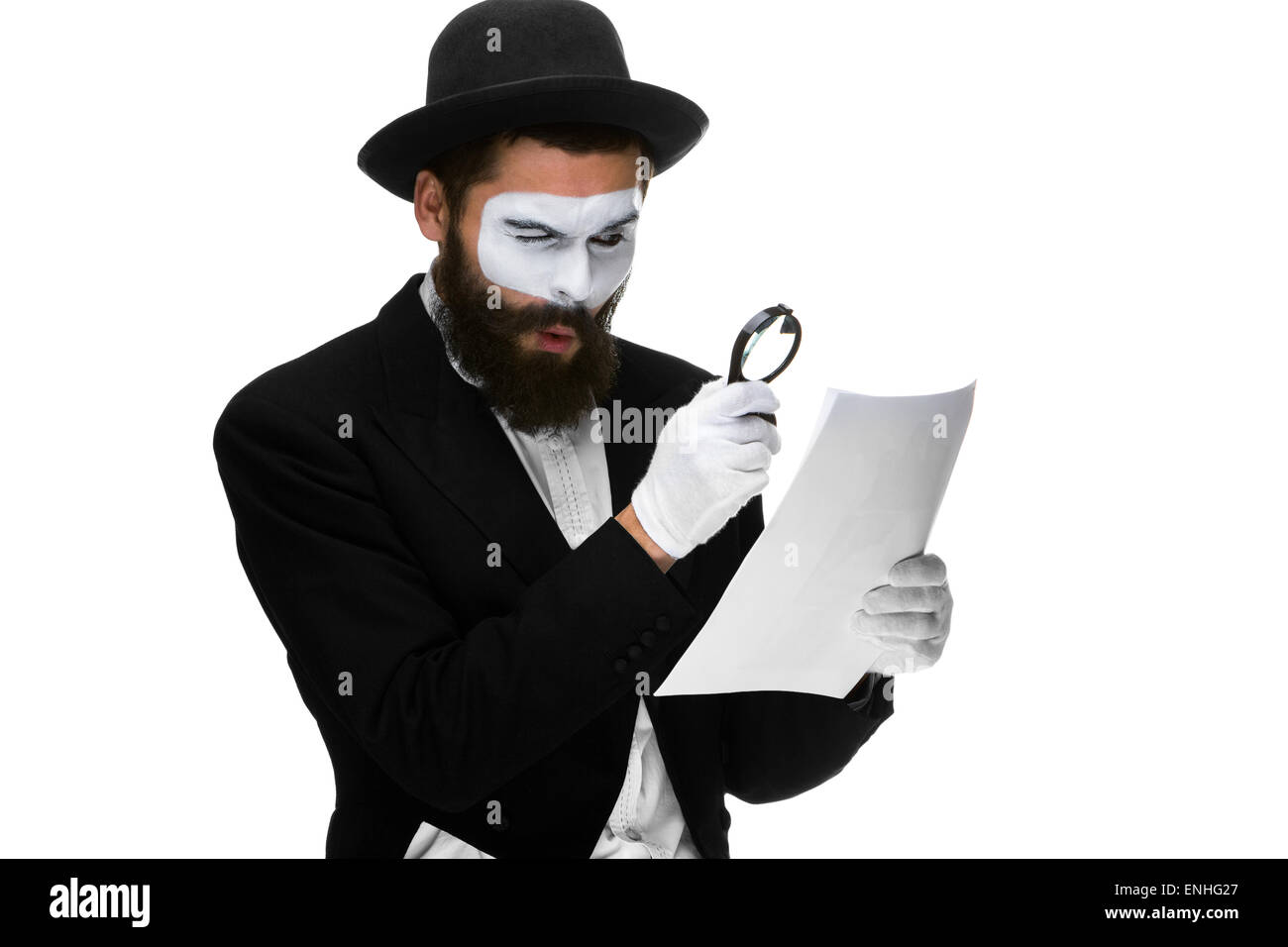 Man with a face mime reading through magnifying glass Stock Photo - Alamy