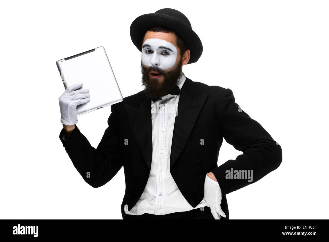 Man with a face mime working on a laptop isolated on a white background ...