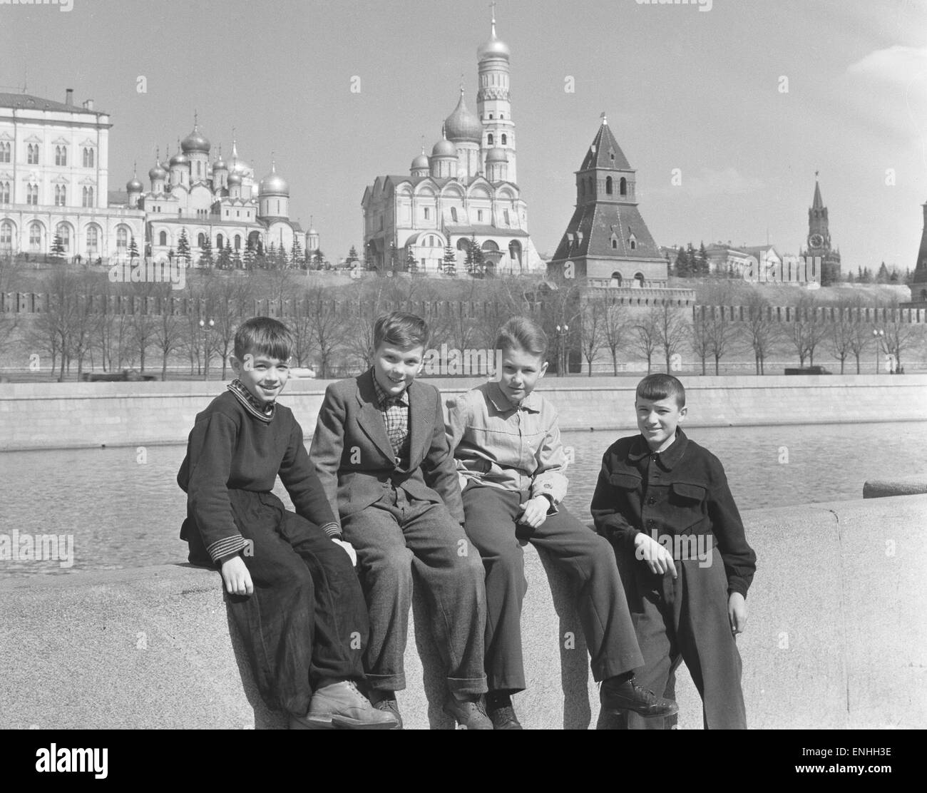 Four schoolchildren pose on the banks of the Moskva River in Moscow. In ...