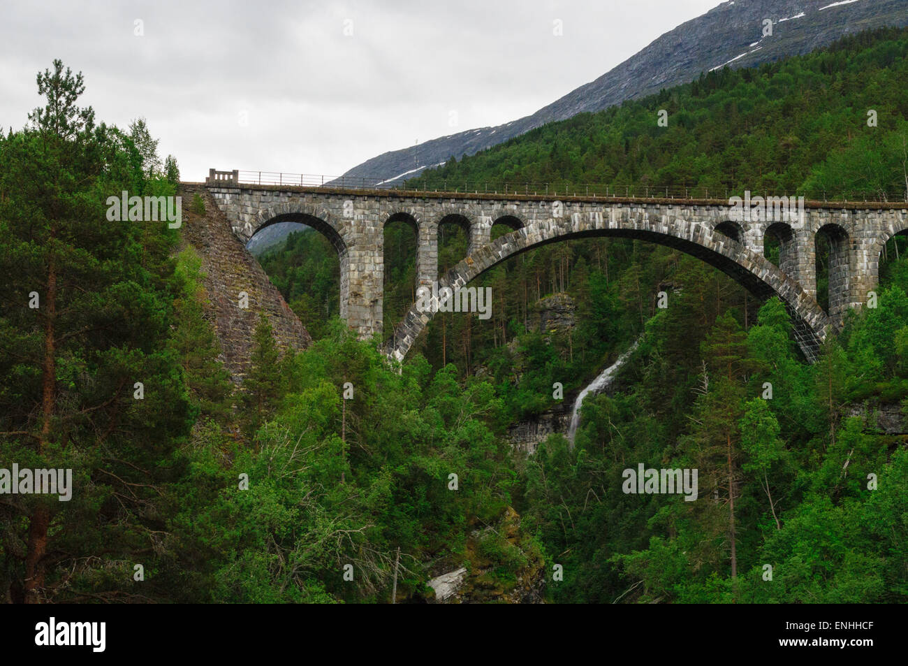 Arch stone bridge in norwegian forest valley Stock Photo - Alamy