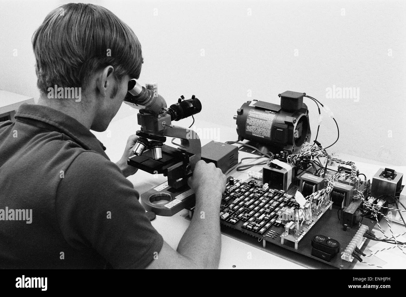 Silicon Valley, Santa Clara, California, USA, August 1978. Technician examines board of micro ...