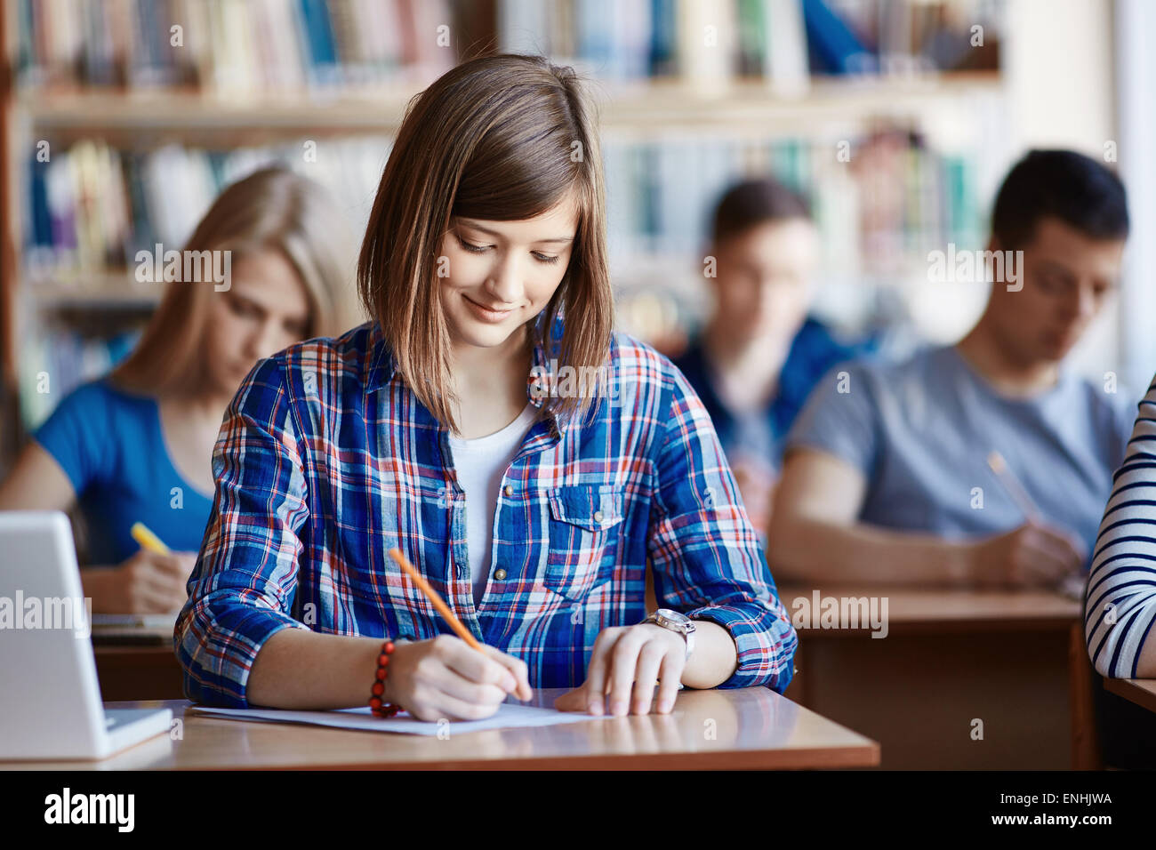 Highschool student carrying out task at workplace Stock Photo - Alamy