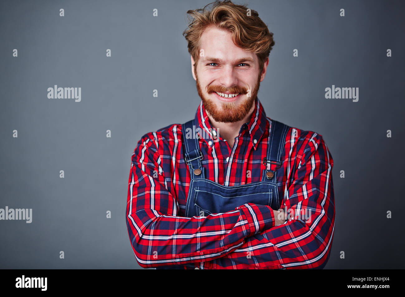 Handsome guy in coveralls looking at camera with smile Stock Photo - Alamy