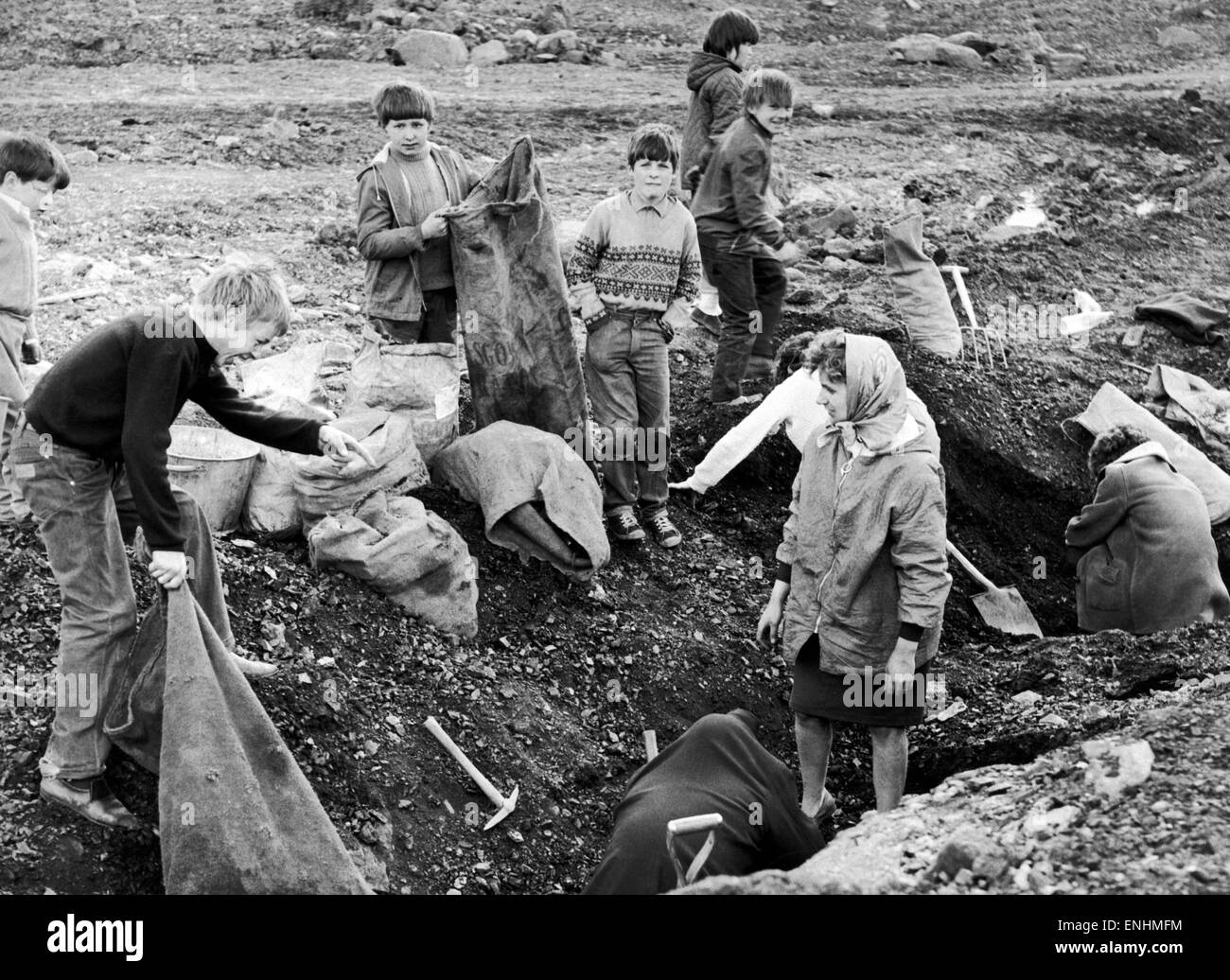 A woman and children join in the coal dig at the new Kilmarnoch site ...
