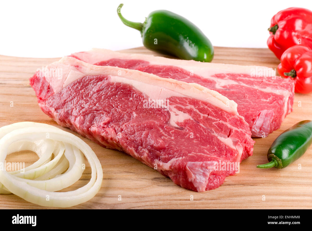 Two steaks with habanero, sliced onion and jalapeno Stock Photo - Alamy