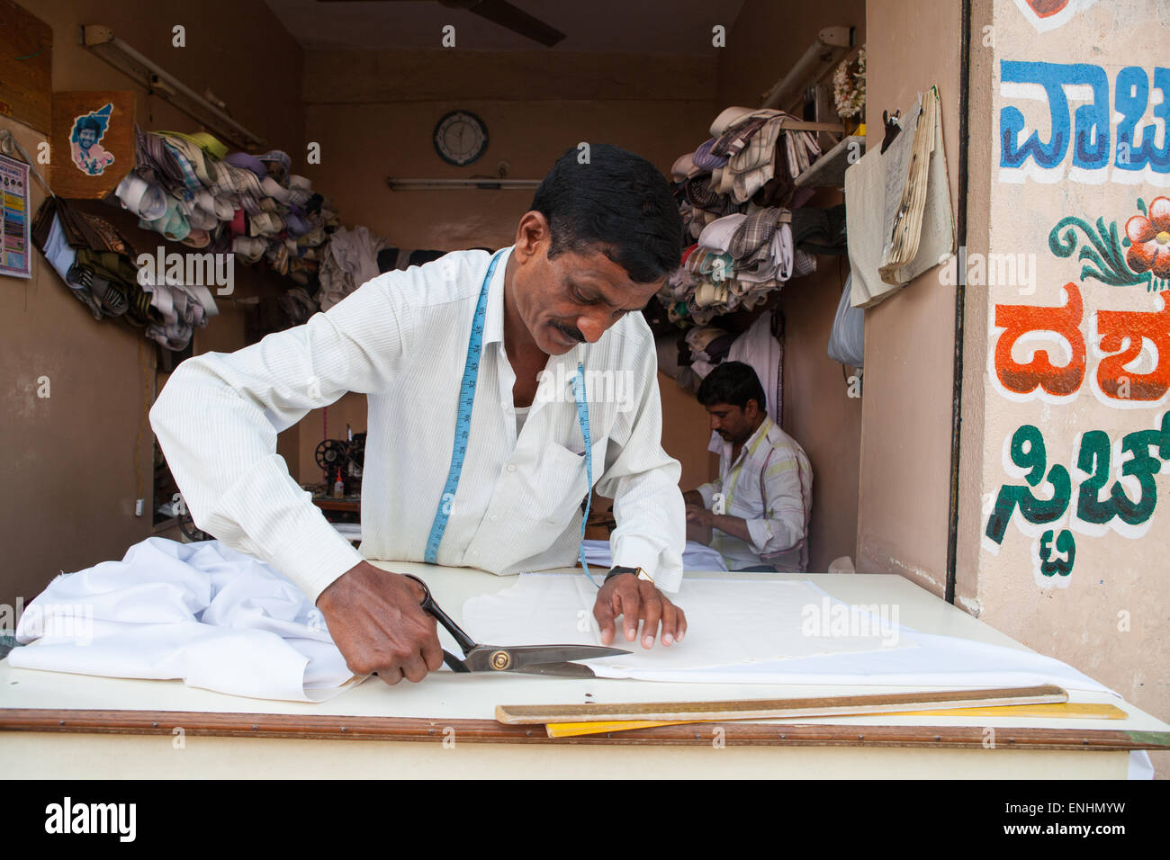 Tailor cutting cloth hi-res stock photography and images - Alamy