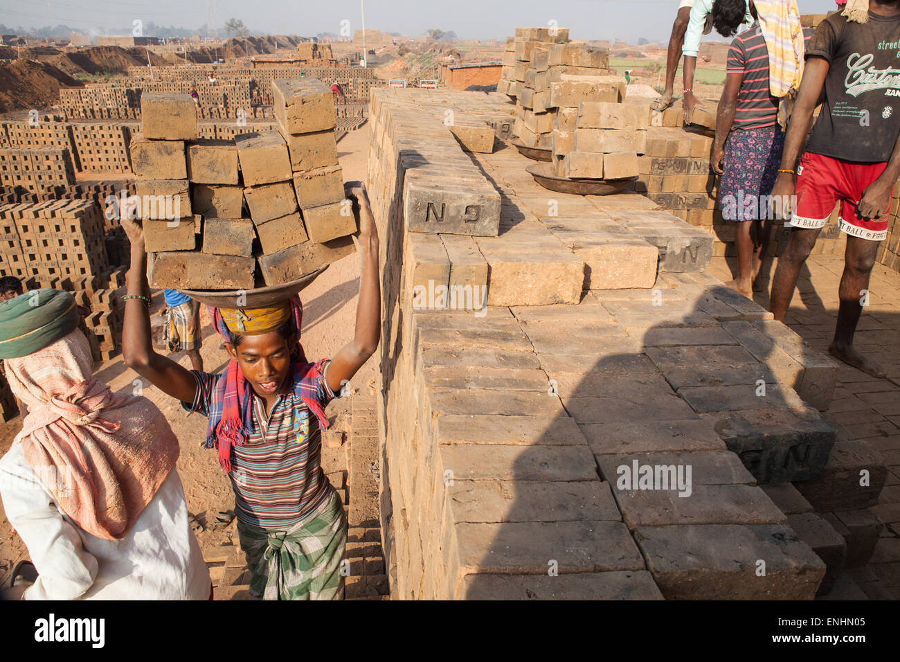 Men carrying bricks on their head at a brick making factory in ...
