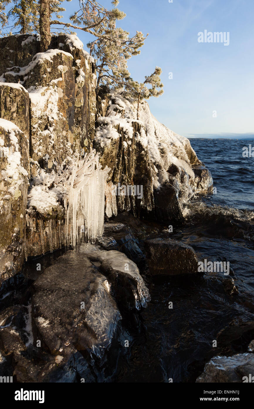 Frozen lakefront rock cliff Stock Photo - Alamy