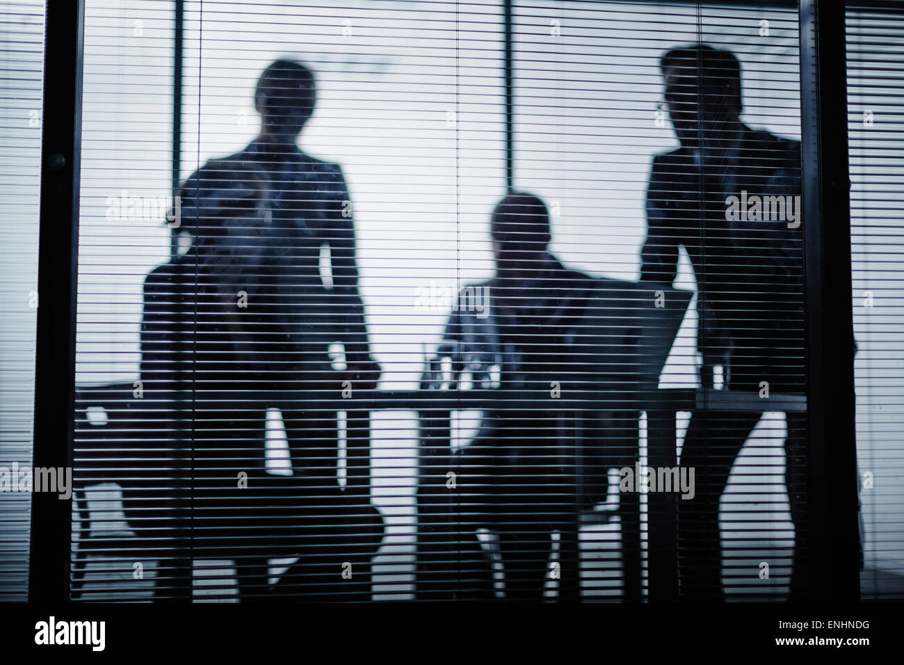 Several employees gathered by workplace in office Stock Photo - Alamy