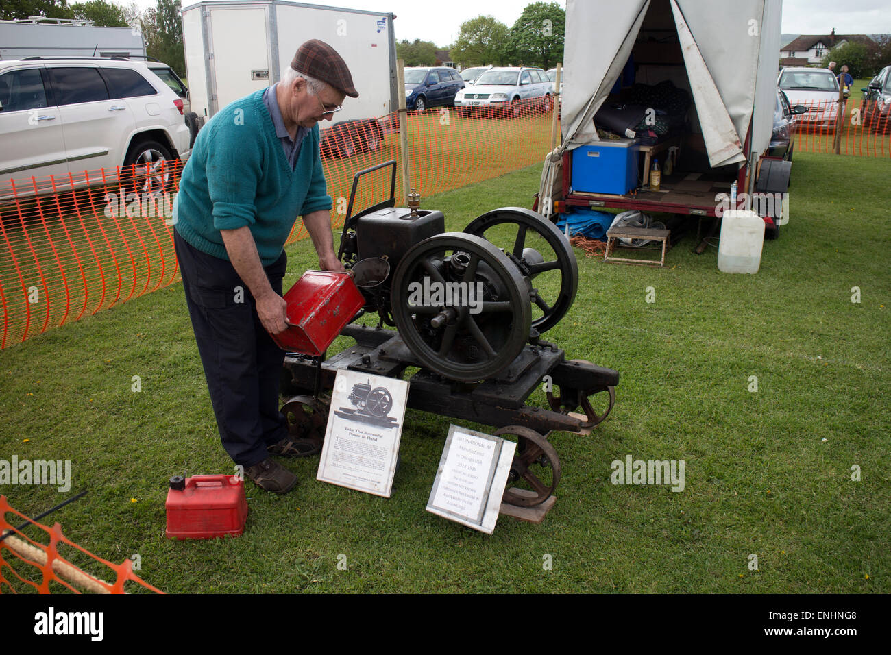 Man filling up International M stationary engine with petrol Stock ...